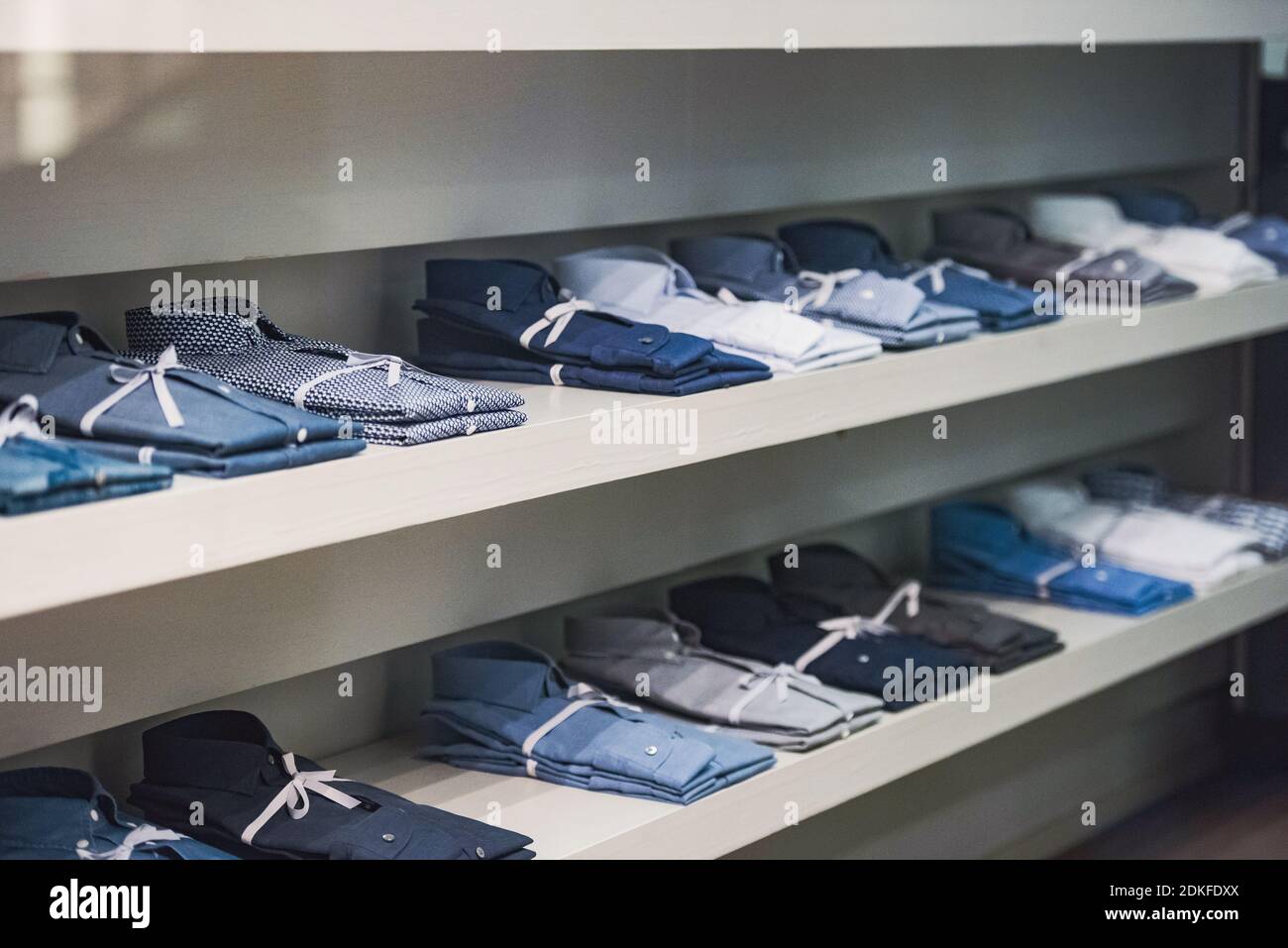 Men shirts in a clothing store - shopping concept Stock Photo - Alamy