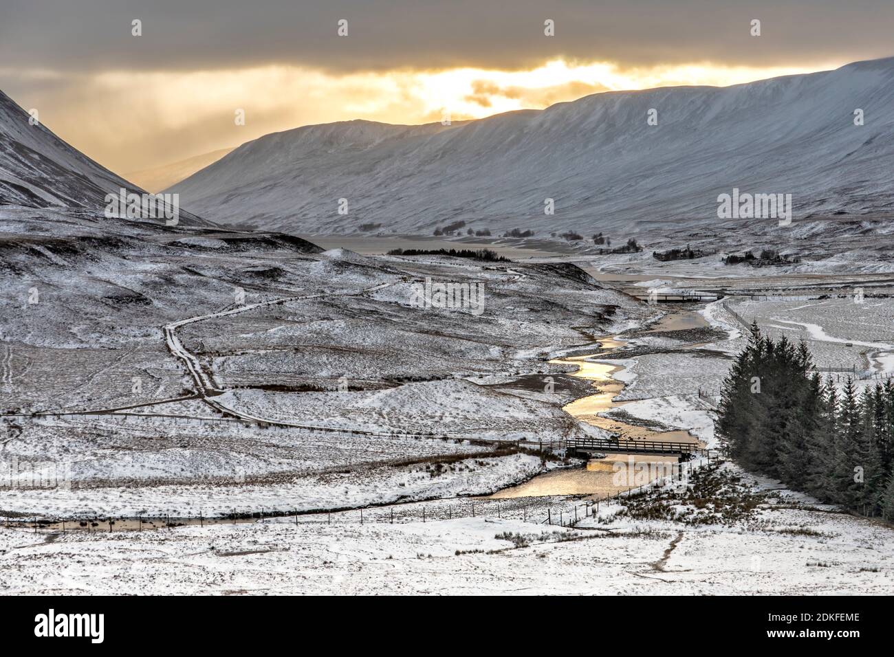 View into a snow-covered valley as the River Garry in Scotland meanders ...