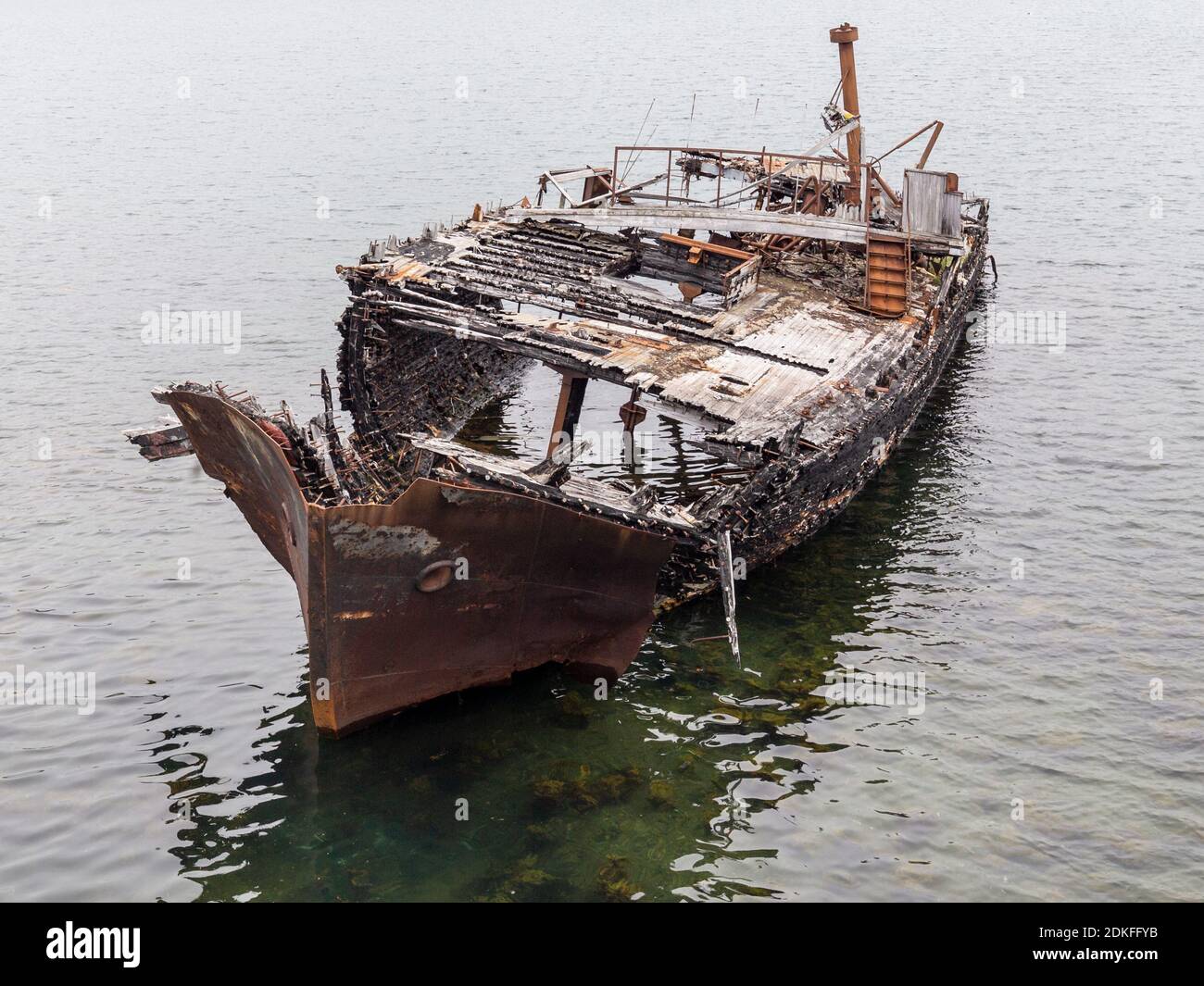 Rotting, abandoned ship on a water of sea, a symbol of decadence and ...