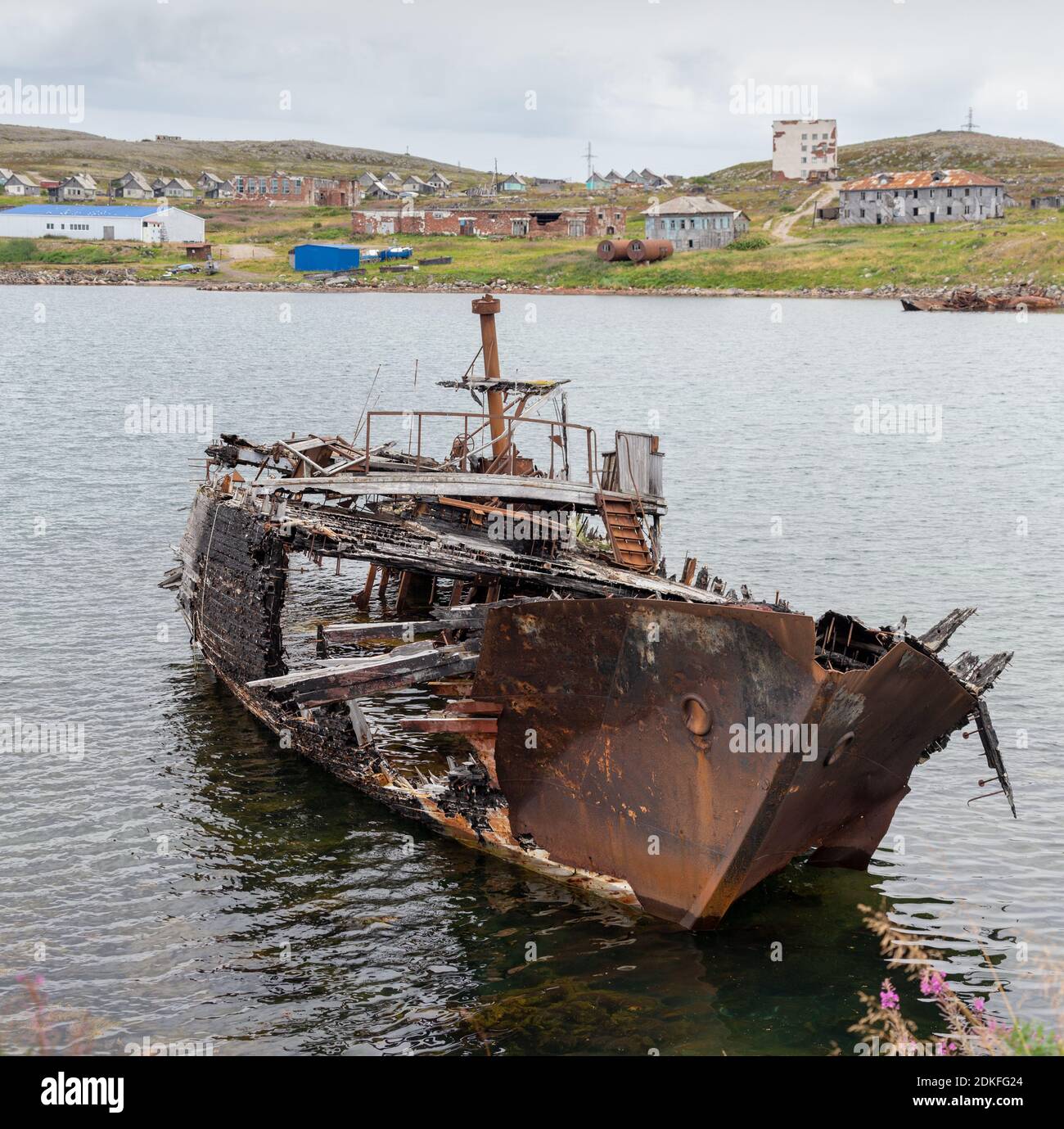 Rotting, abandoned ship on a water of sea bay against the background of ...