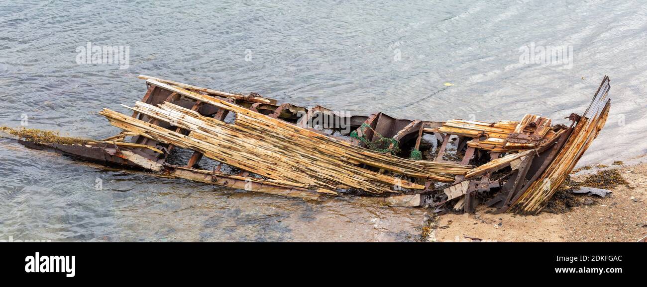 Rotting, abandoned ship on the shore, a symbol of decadence and ...