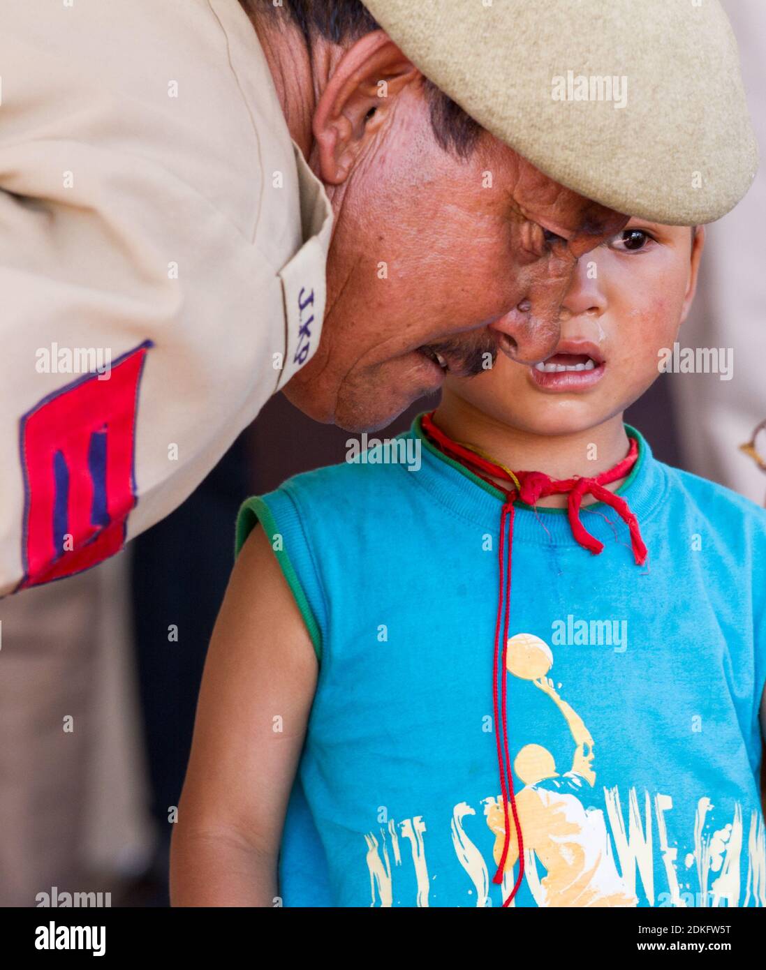 Leh, India - August 7, 2012: Military man comforting a crying baby boy ...
