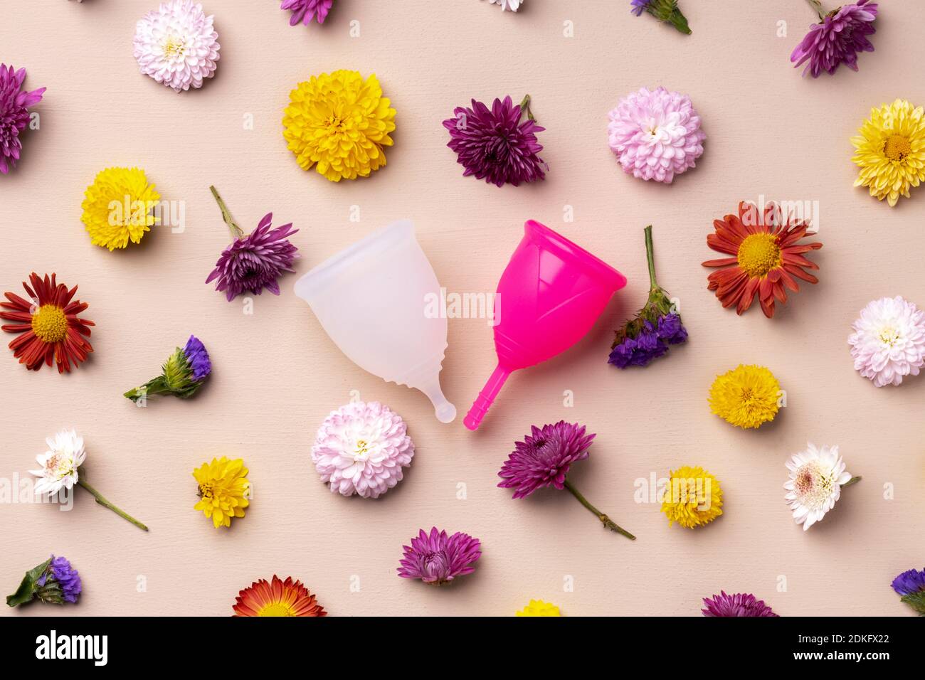 Menstrual cup on floral pattern background top view Stock Photo - Alamy