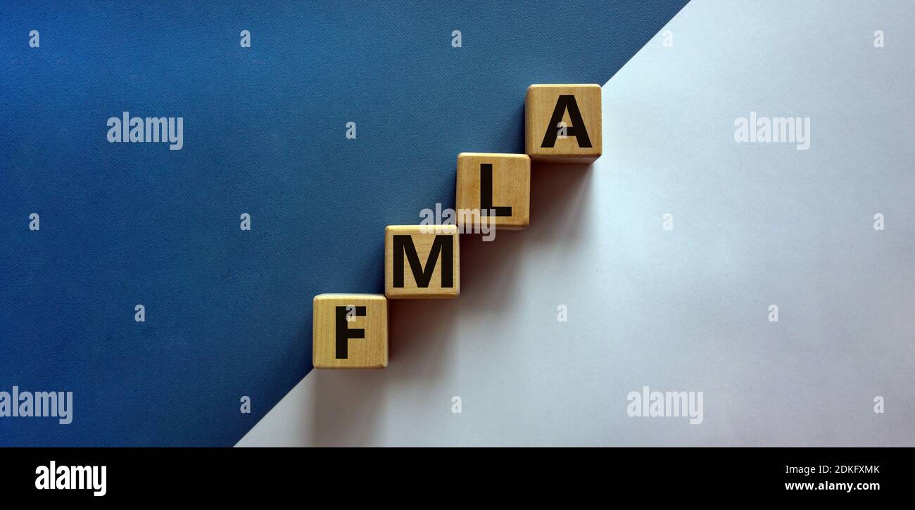 FMLA symbol. Wood cubes with word 'FMLA - family medical leave act ...