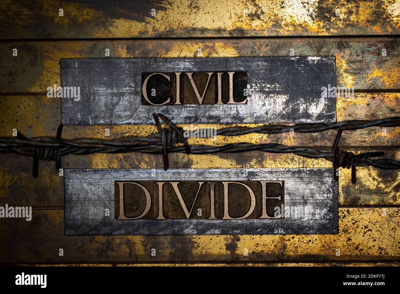Civil Divide text on grunge textured corroded copper and gold ...