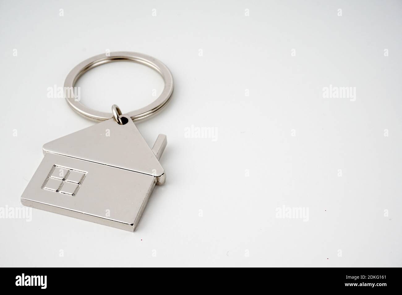 Key and keychain in the shape of a house isolated on white background ...