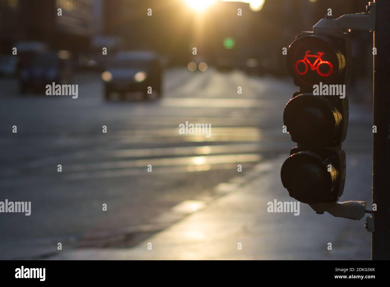 Red bicycle traffic light with cars, traffic in the background during ...