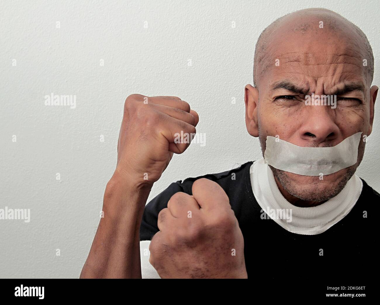 men feeling the pain after being discriminated with tape over his mouth ...