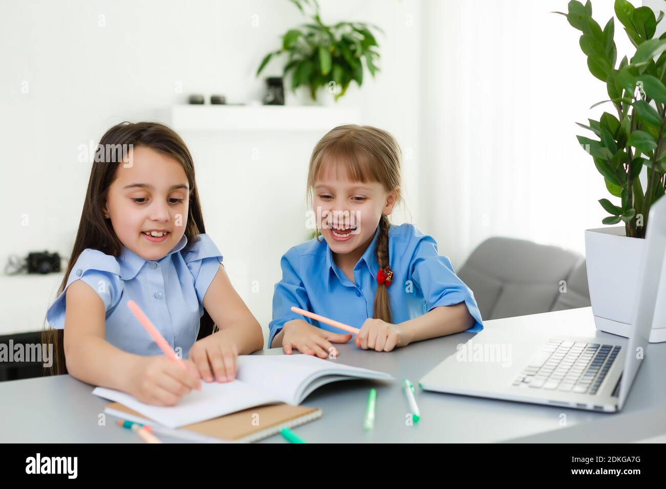 Cool online school. Kids studying online at home using a laptop ...