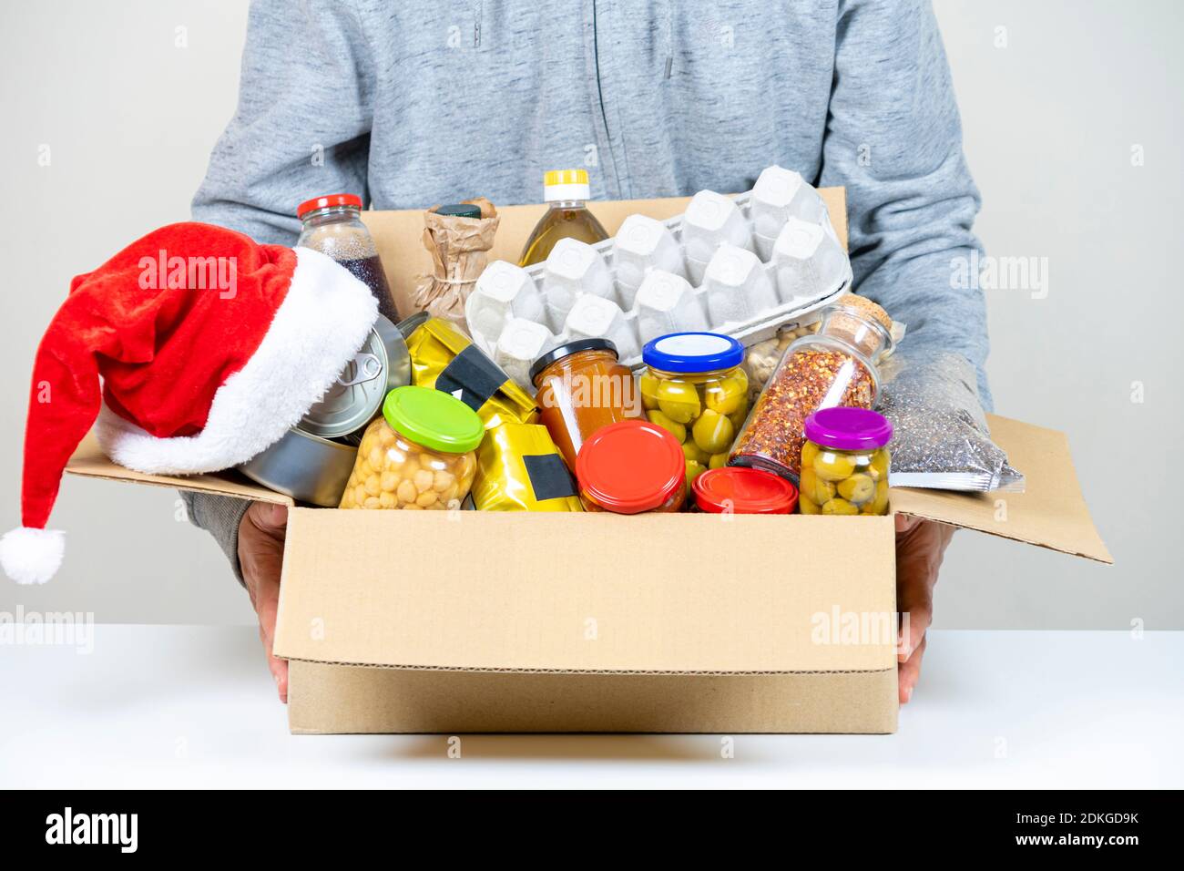 Christmas donation. Volunteer holding food donation box with grocery ...