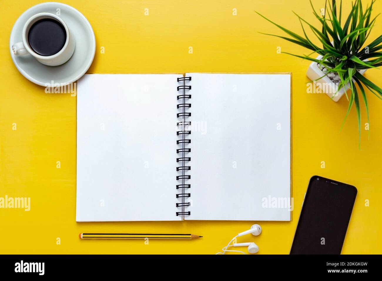 Notebook mockup on yellow office desk. Top view. Isolated blank sheet ...