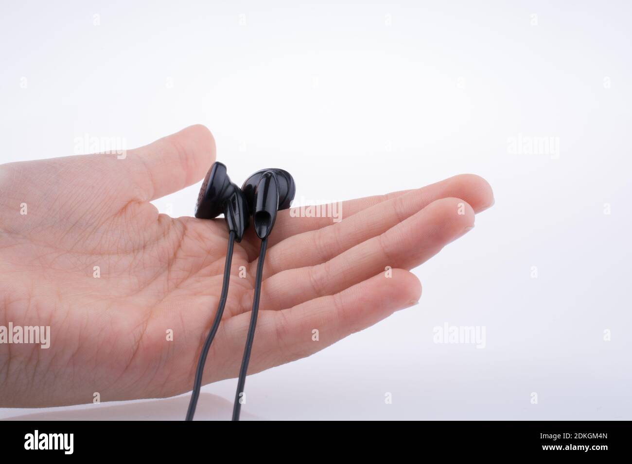 Hand holding ear buds hi-res stock photography and images - Alamy