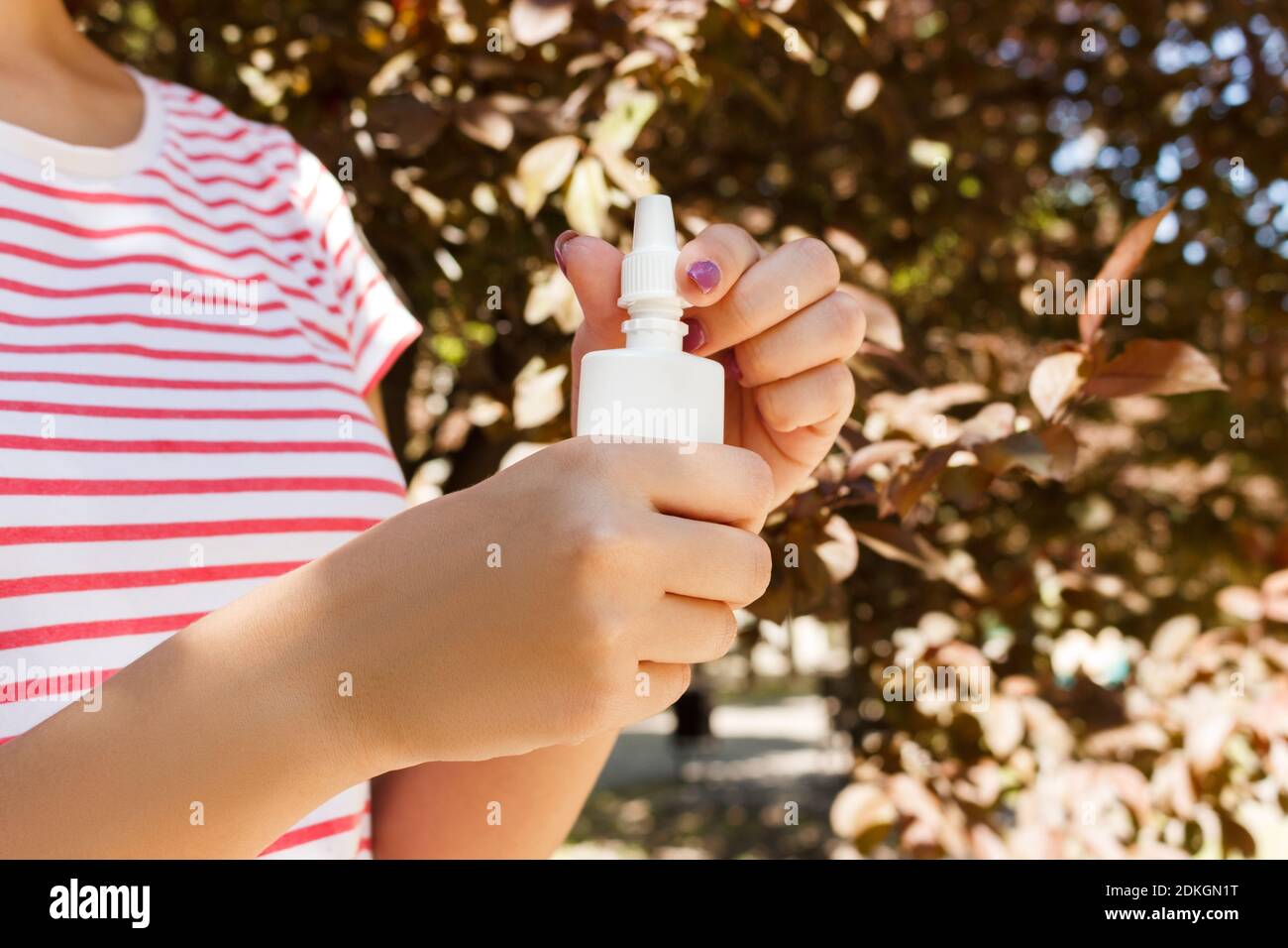 nasal drops bottle, Female hand spraying nasal spray with blurred ...