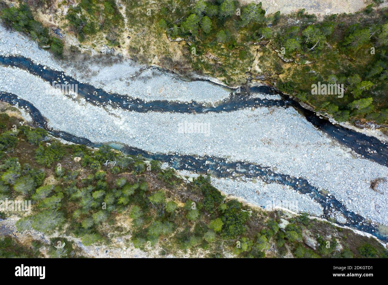 Aerial shots of mountain stream at the tree line in the high mountains ...