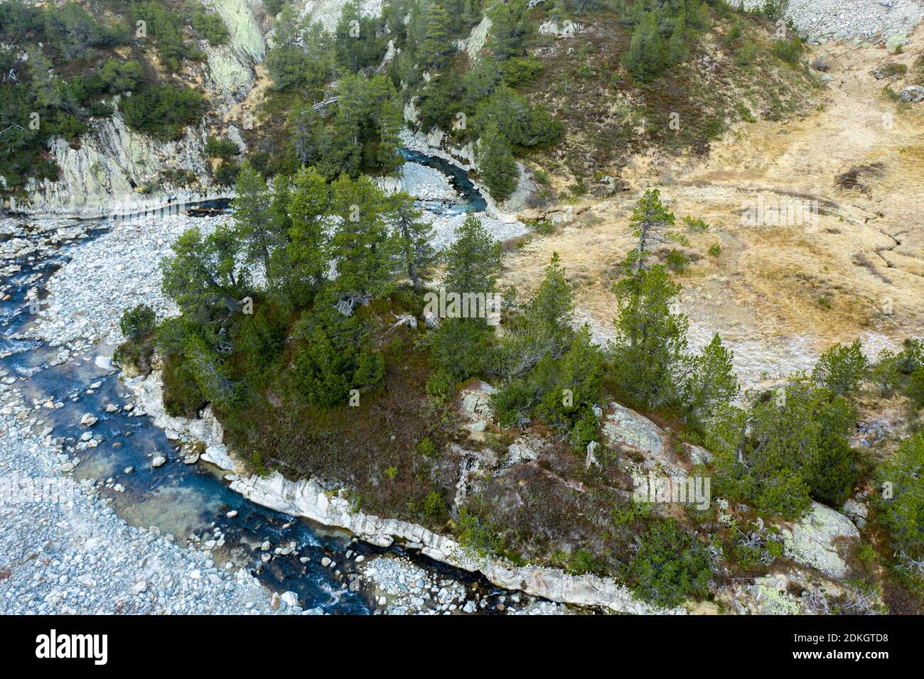 Aerial shots of mountain stream at the tree line in the high mountains ...