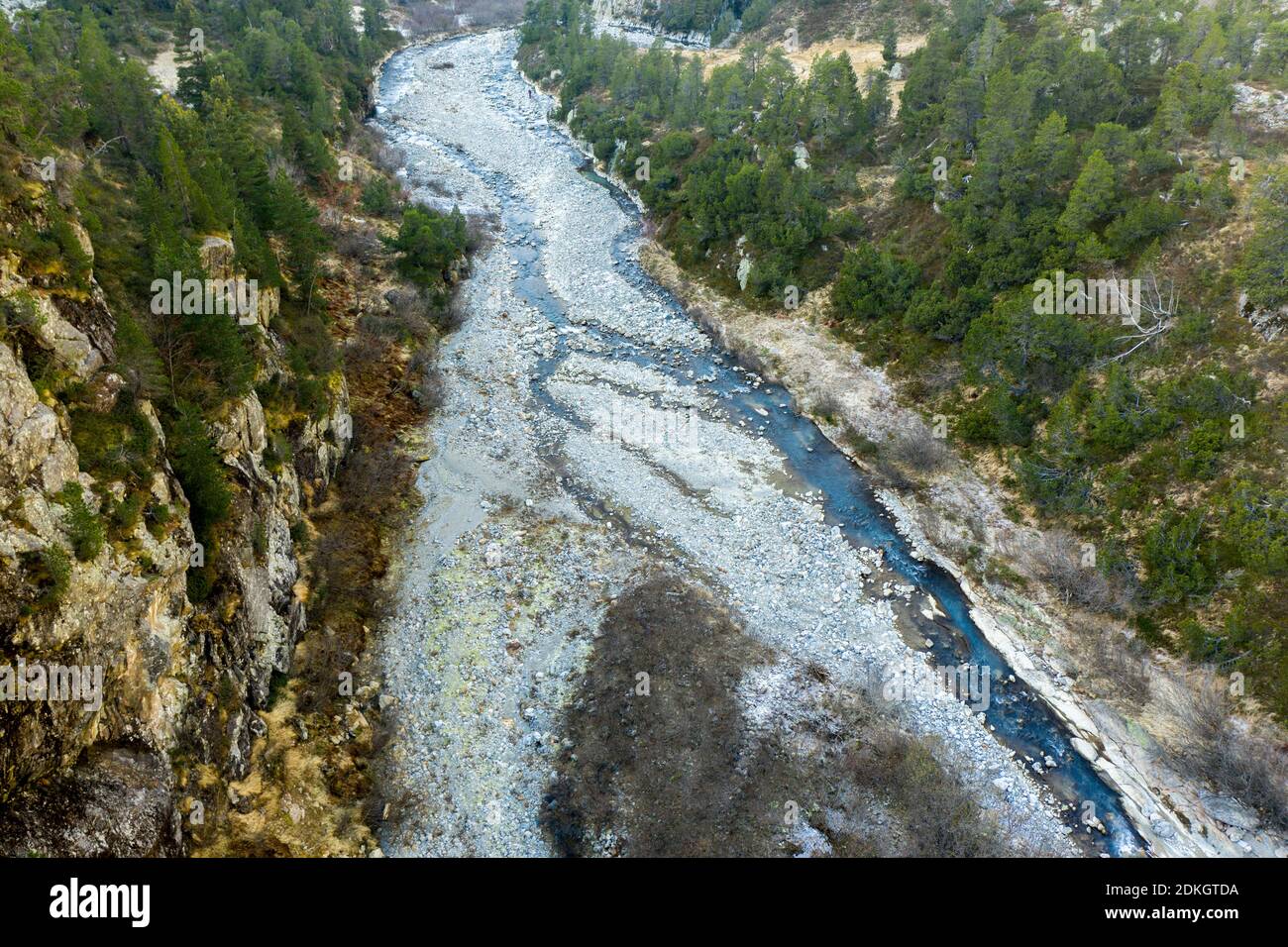 Aerial shots of mountain stream at the tree line in the high mountains ...