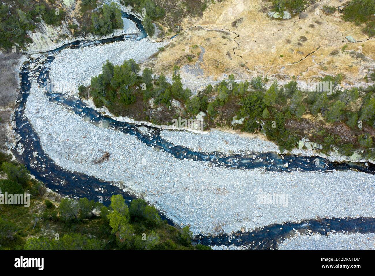 Aerial shots of mountain stream at the tree line in the high mountains ...