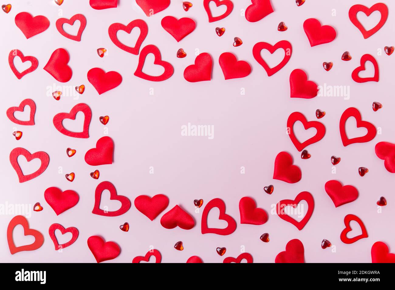 Rectangle frame made of various types of hearts on the pink background ...