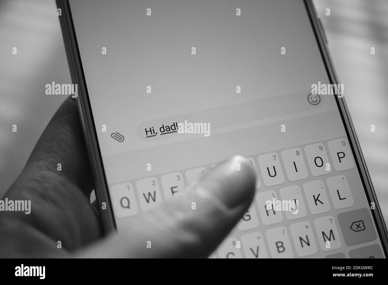 Human hand typing on a white smartphone a message Hello, winter. BW ...