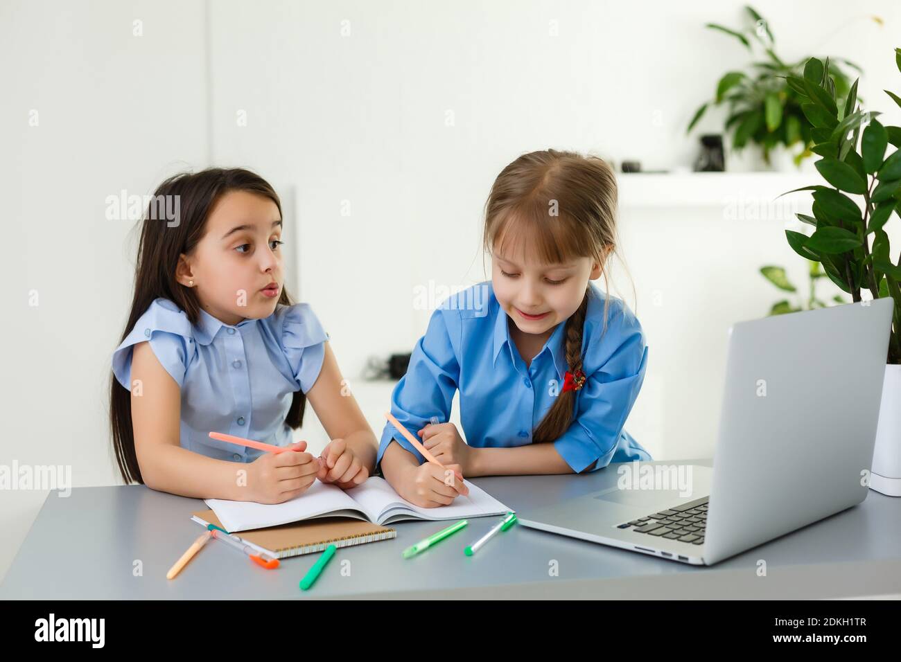 Cool online school. Kids studying online at home using a laptop ...