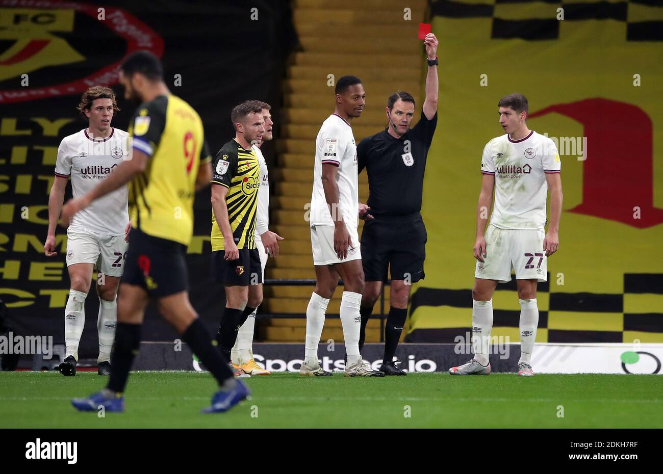 Brentford's Ethan Pinnock is shown a red card by referee James ...