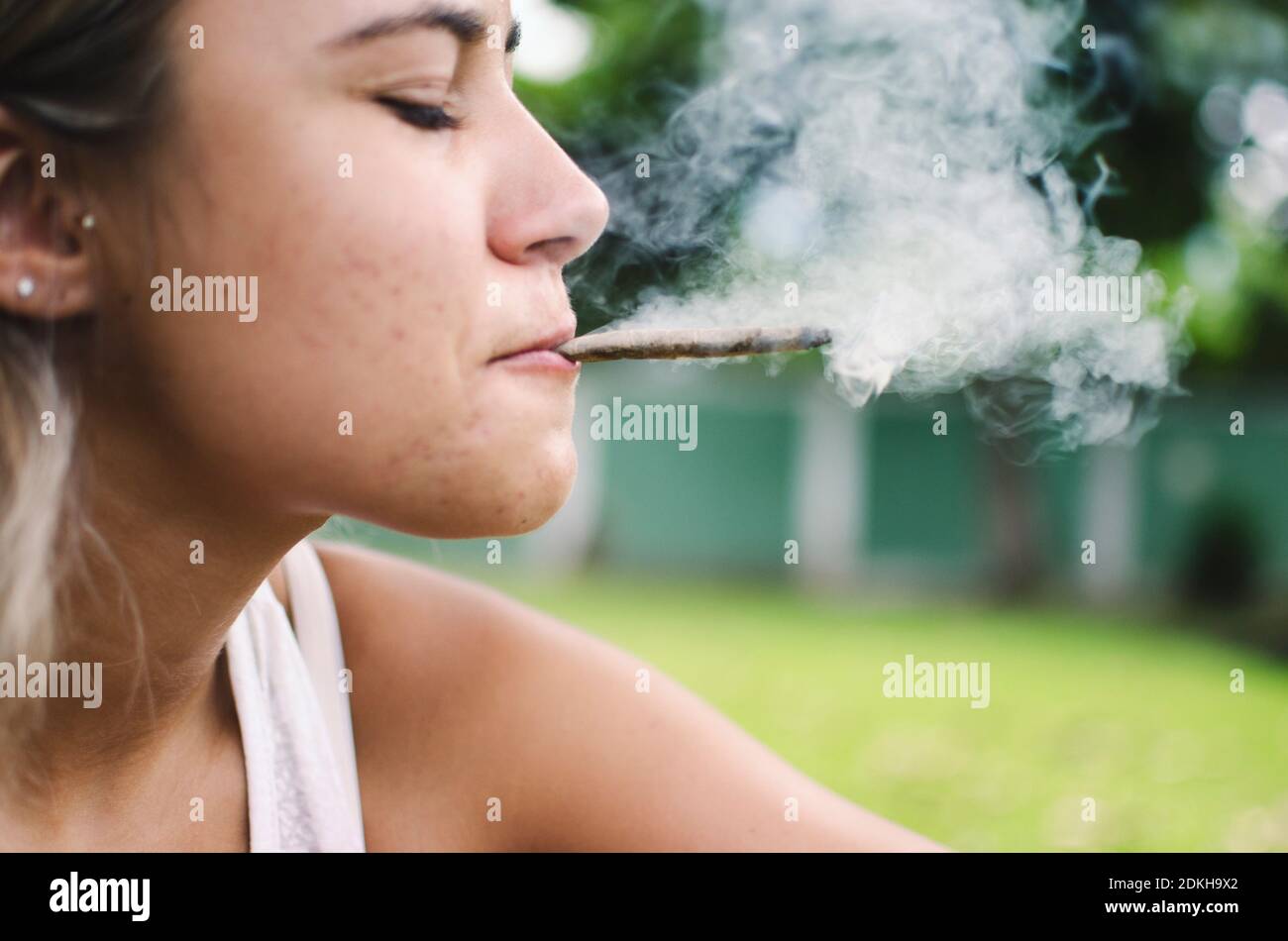 Woman smoking rolled up cigarette hi-res stock photography and images ...