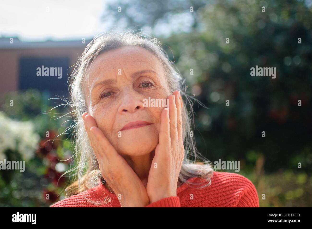 Portrait of a mature woman with grey hair spending time outdoors during ...