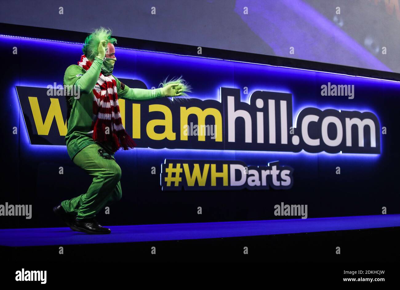 Peter Wright walks on stage dressed as The Grinch in front of a William ...