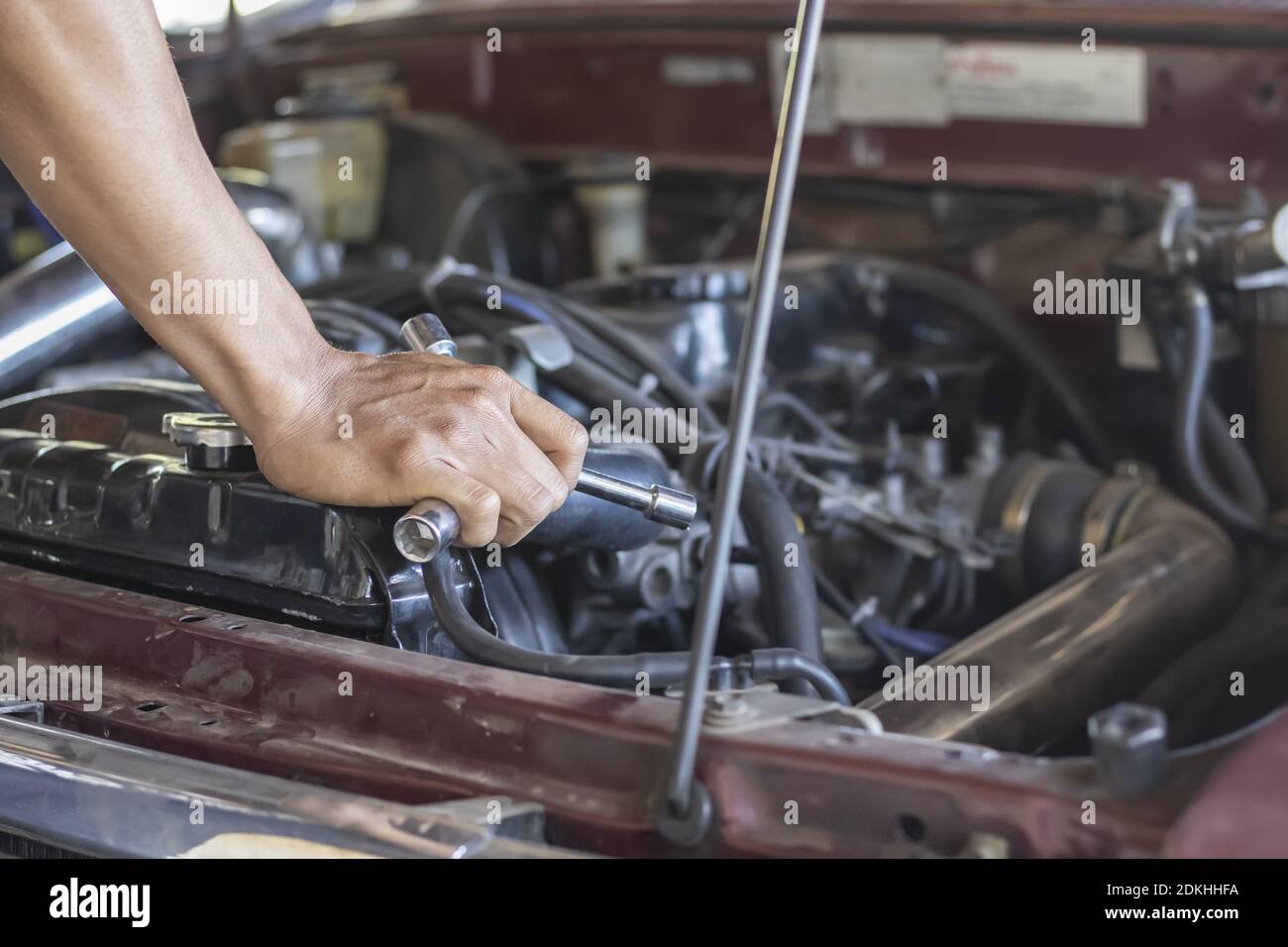 The hand of a man who is fixing a broken car's engine Stock Photo - Alamy