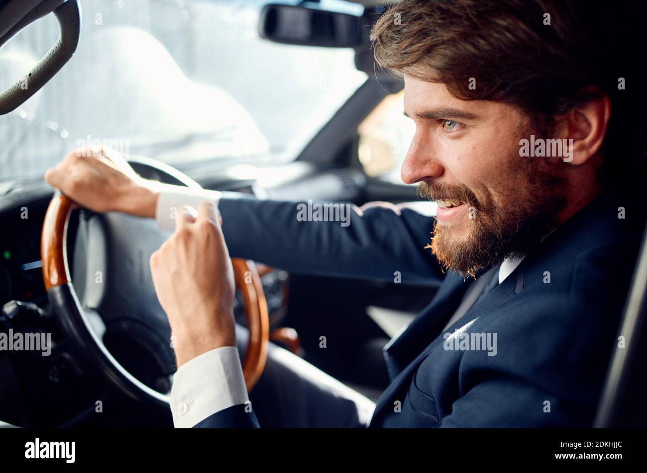 man driving a car trip road official wealth Stock Photo - Alamy