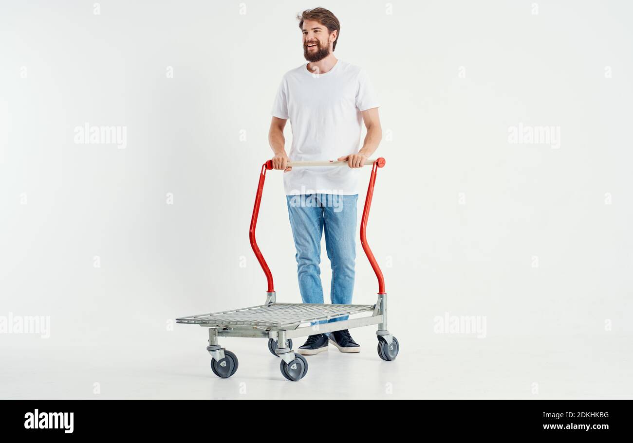 a man in a cargo trolley on a light background superhero transporting ...