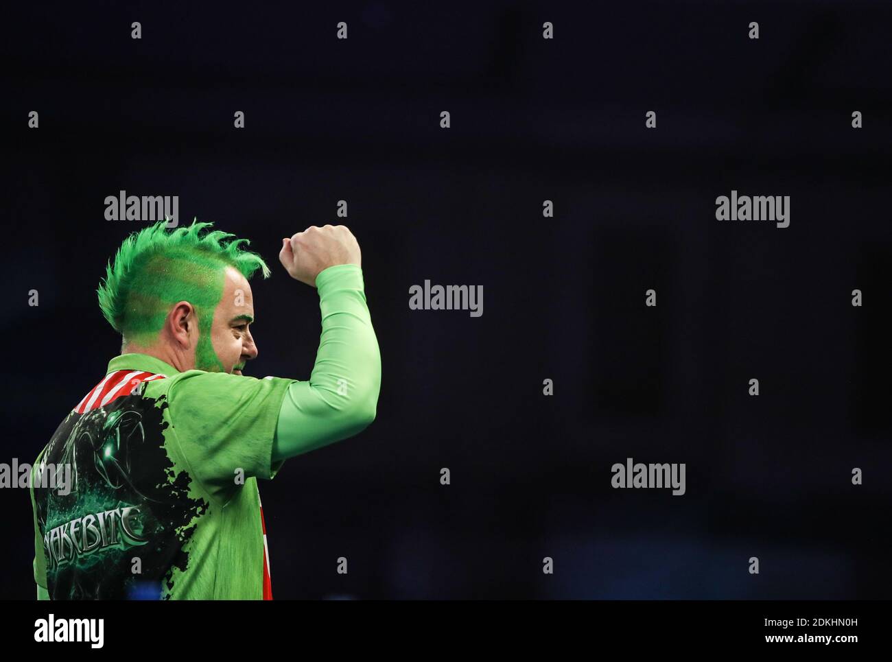 Peter Wright raises his arm to the crowd after beating Steve West ...