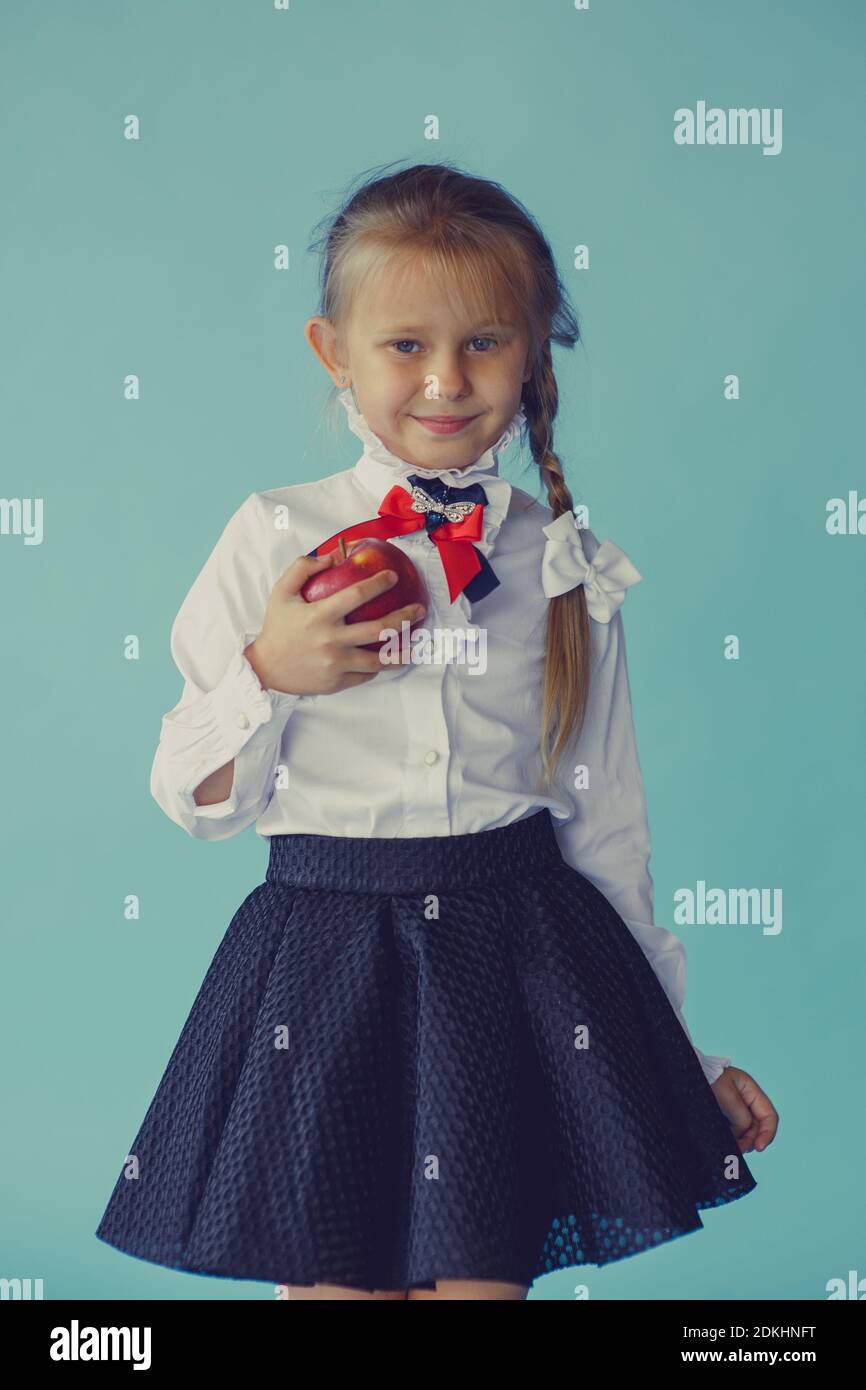 Schoolgirl on blue background. Girl in a school skirt and blouse on a ...