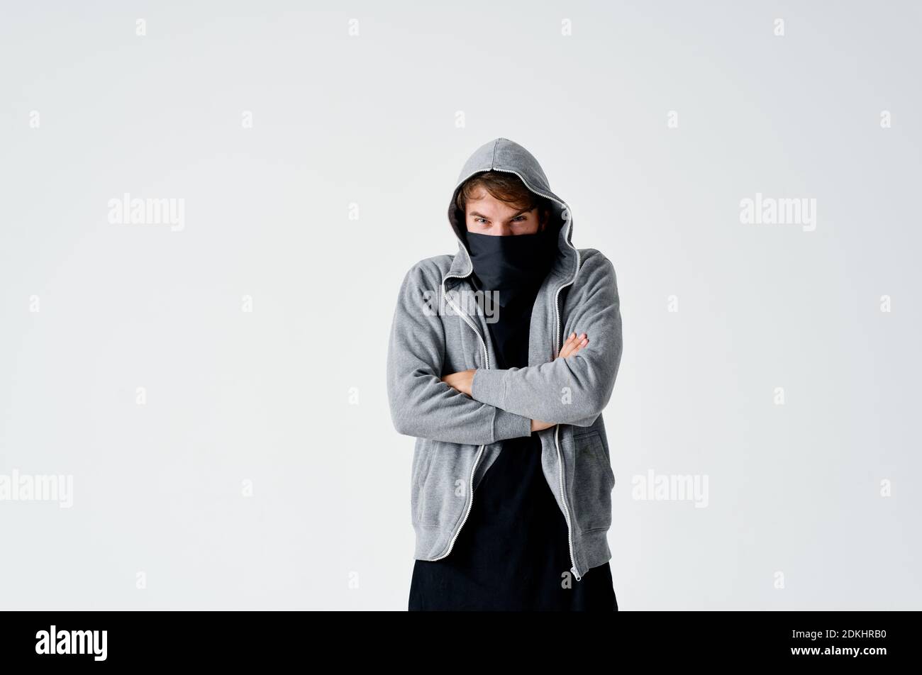 male hacker in a gray sweater stealing black mask on his face Stock ...