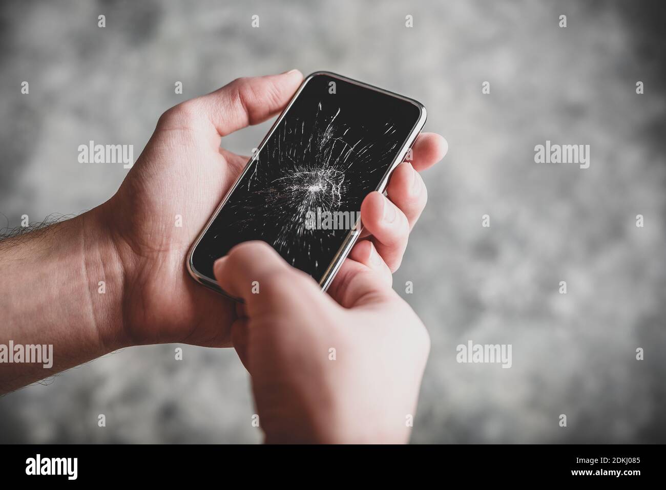 Smart cell phone with a broken screen in hands Stock Photo - Alamy