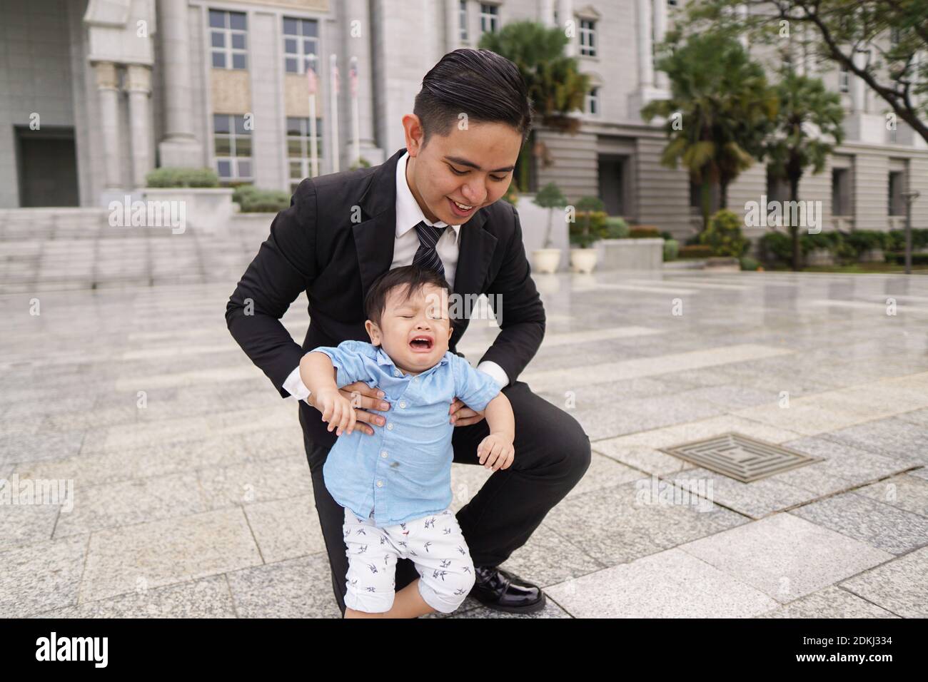 Father carrying crying child hi-res stock photography and images - Alamy