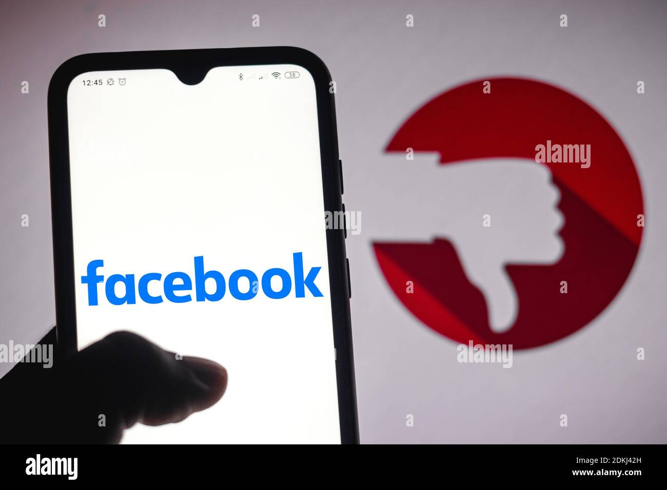 In this photo illustration the Facebook logo seen displayed on a ...
