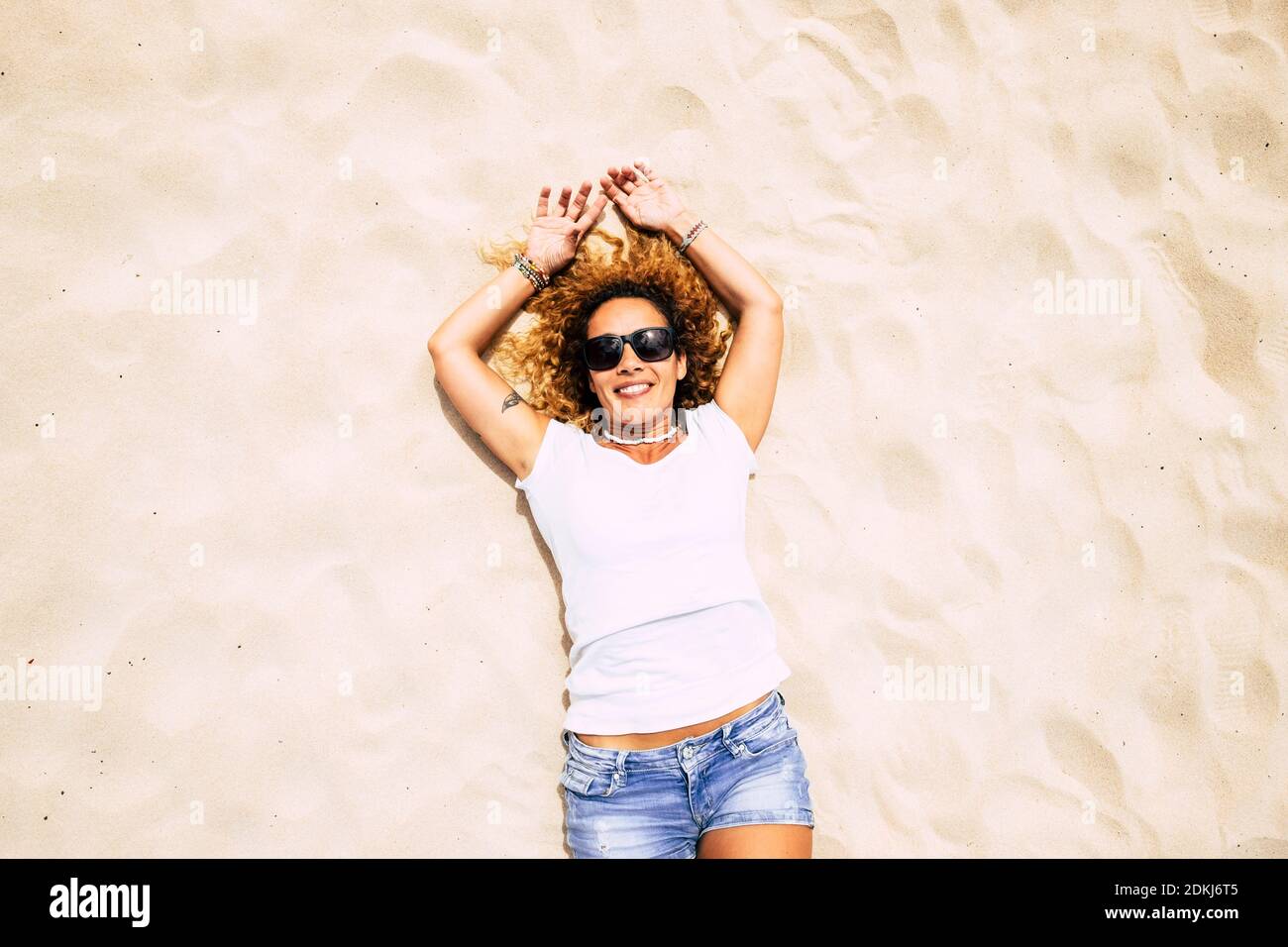 Lady laying on a beach hi-res stock photography and images - Alamy