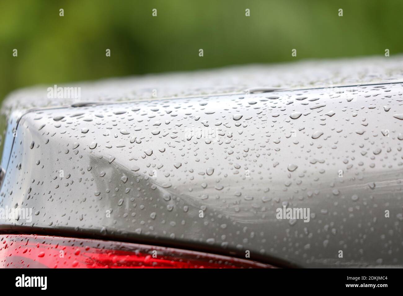 Drops of water dripping on a surface of a black car Stock Photo - Alamy