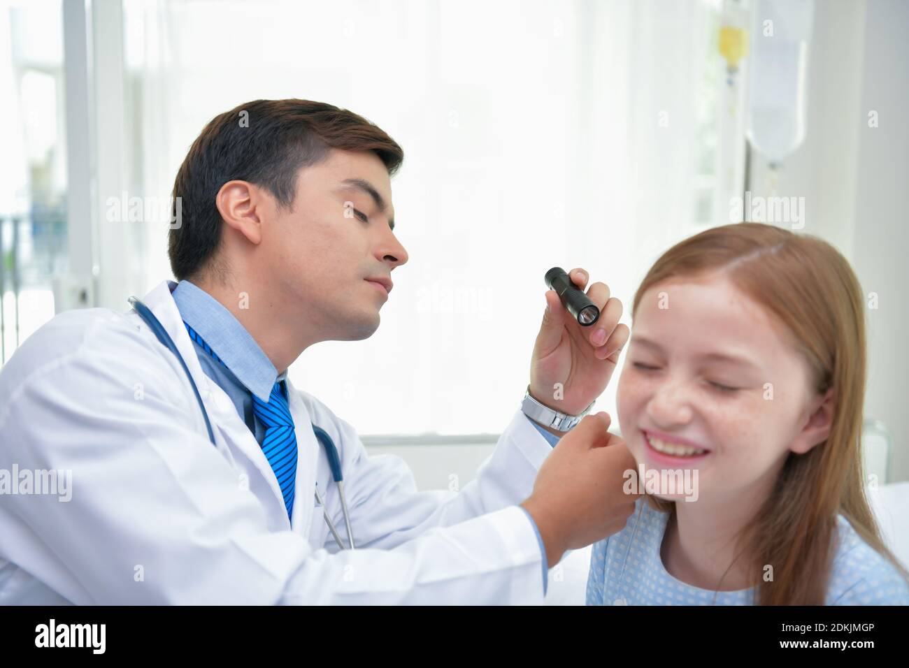 Doctor Checking Girl With Flashlight At Hospital Stock Photo - Alamy