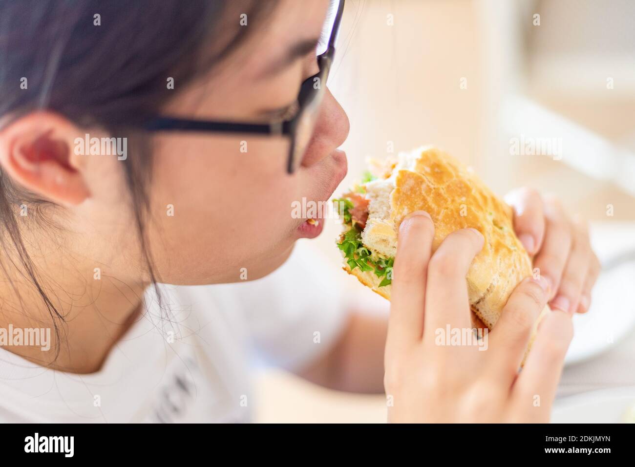 Indian woman eating sandwich hi-res stock photography and images - Alamy