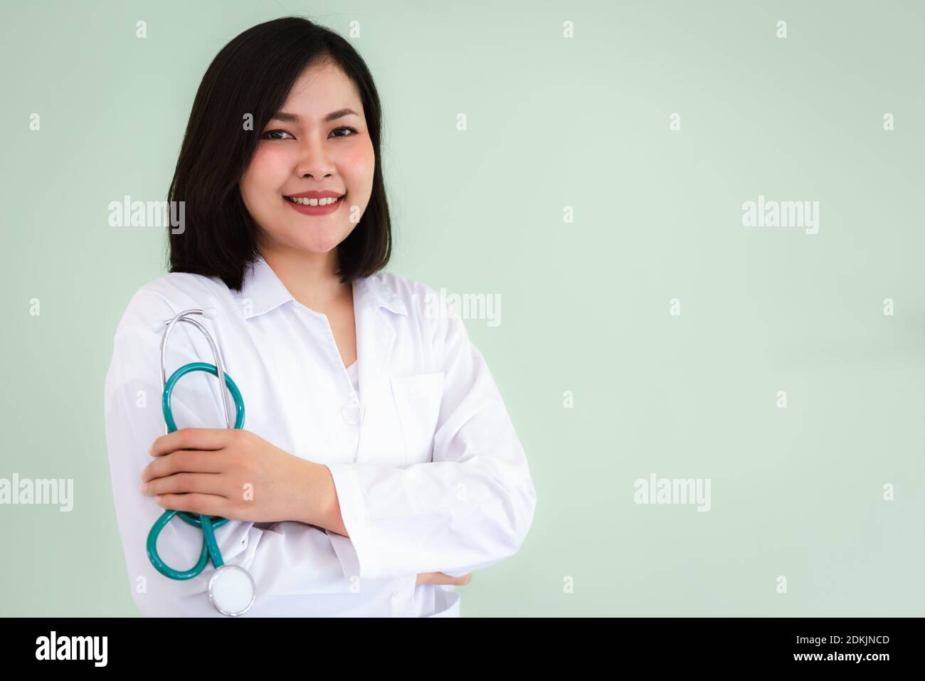 Portrait Of Smiling Female Doctor Holding Stethoscope While Standing ...