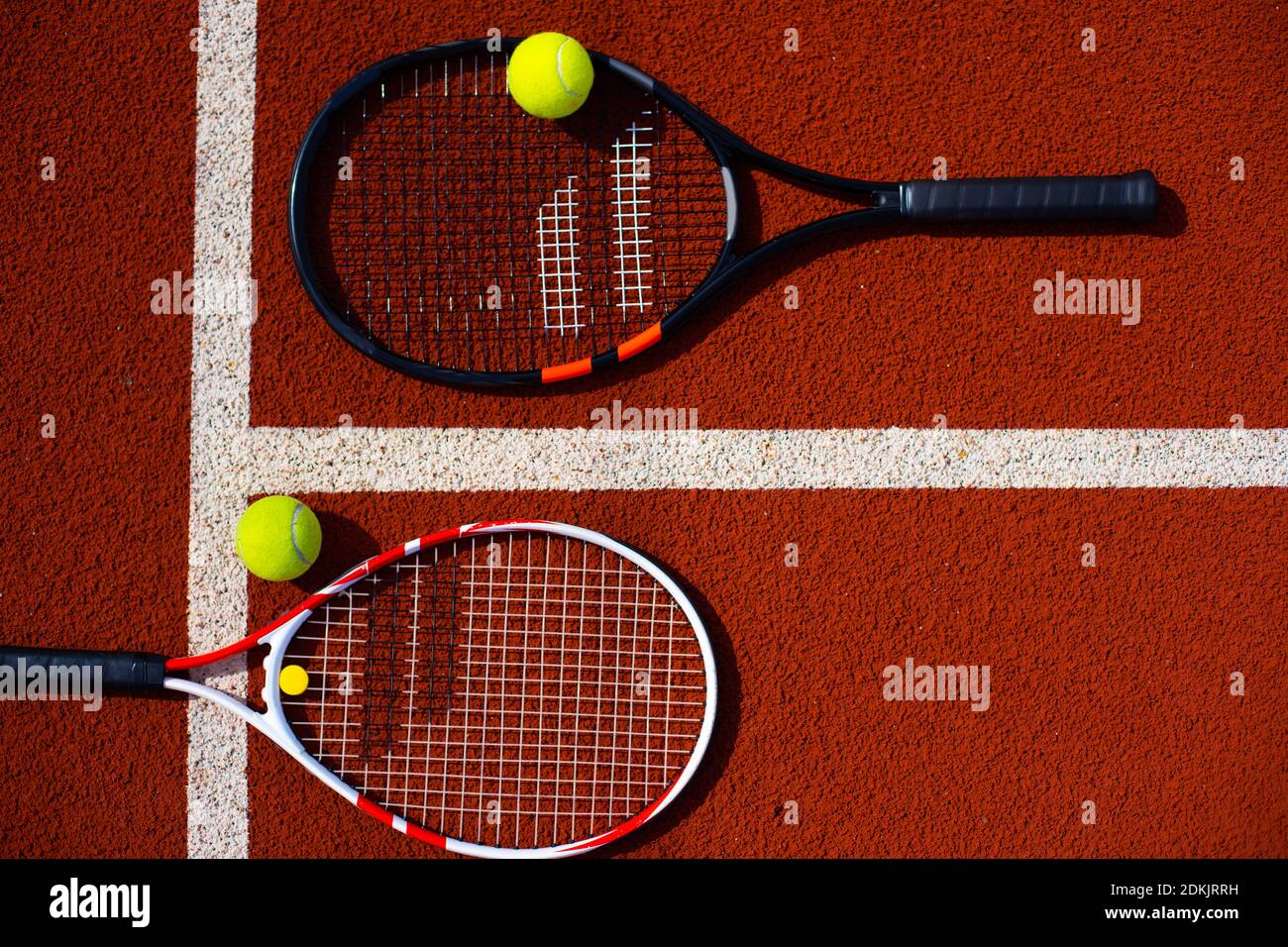 A tennis racket and new tennis ball on a freshly painted tennis court ...