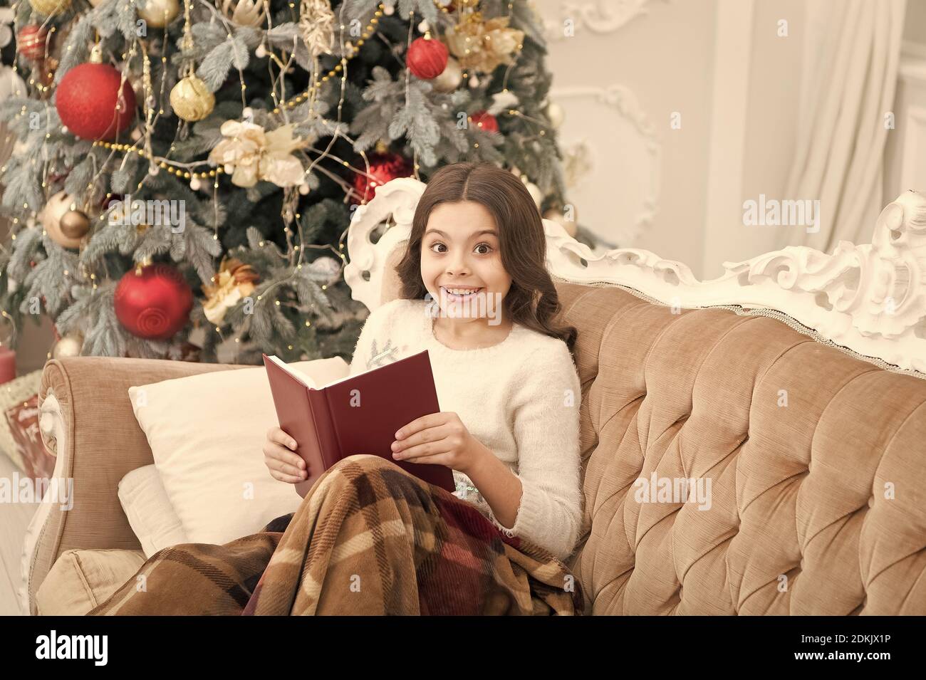 Childhood literature. Winter wonderland. Adorable girl reading book ...