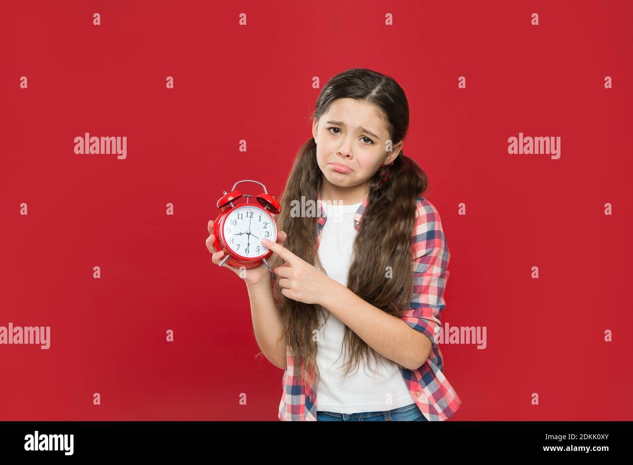 sad teen girl pointing finger on retro alarm clock, countdown Stock ...