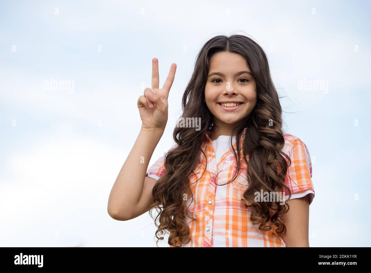 Peace begins with you. Happy child show V hand sign outdoors. World ...