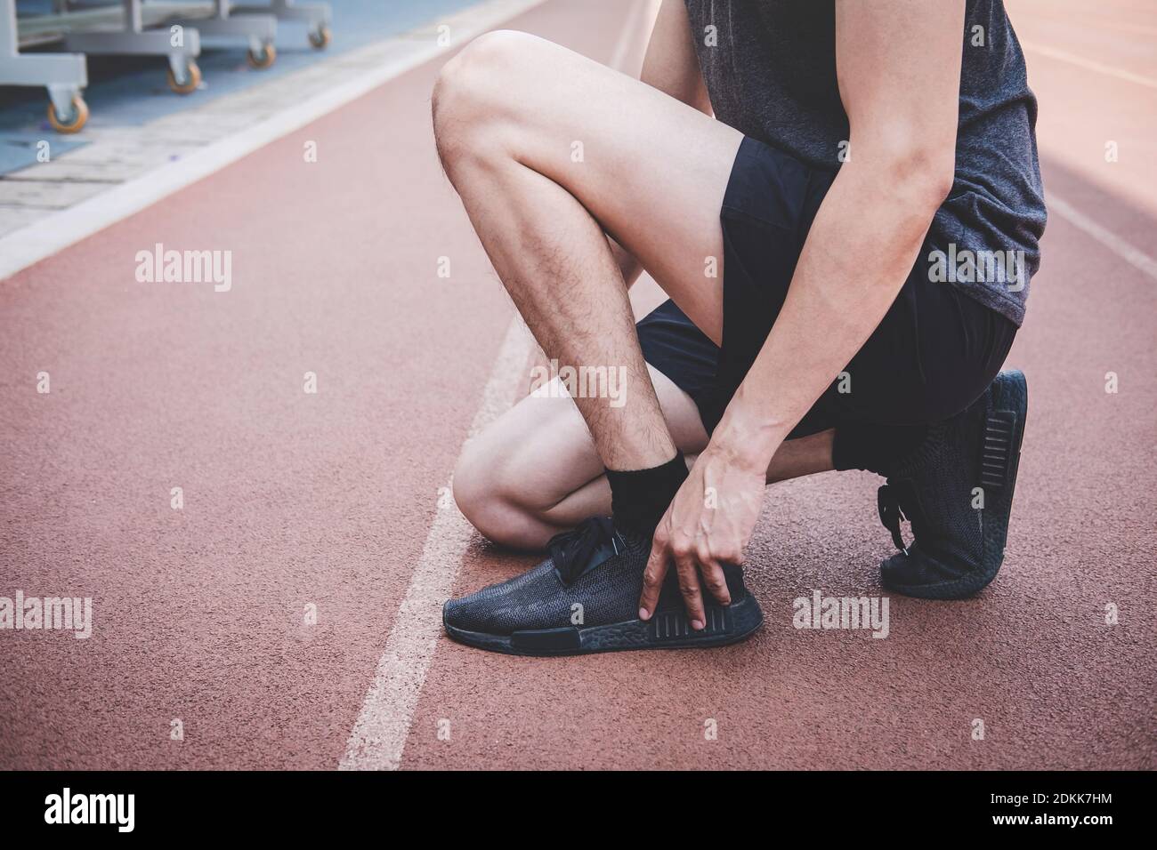Young athlete kneeling sports field hi-res stock photography and images ...