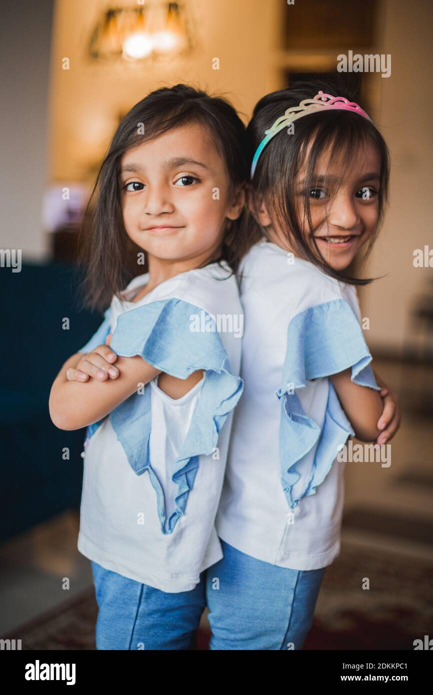 Sisters Back Back Arms Crossed High Resolution Stock Photography and ...