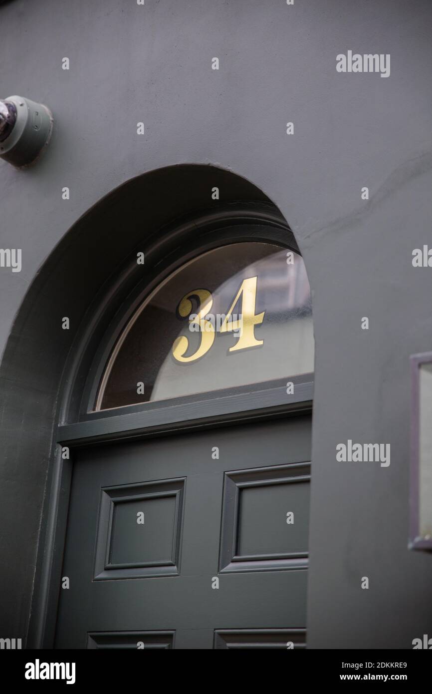 Entrance of dark color building with the number 34 Stock Photo - Alamy
