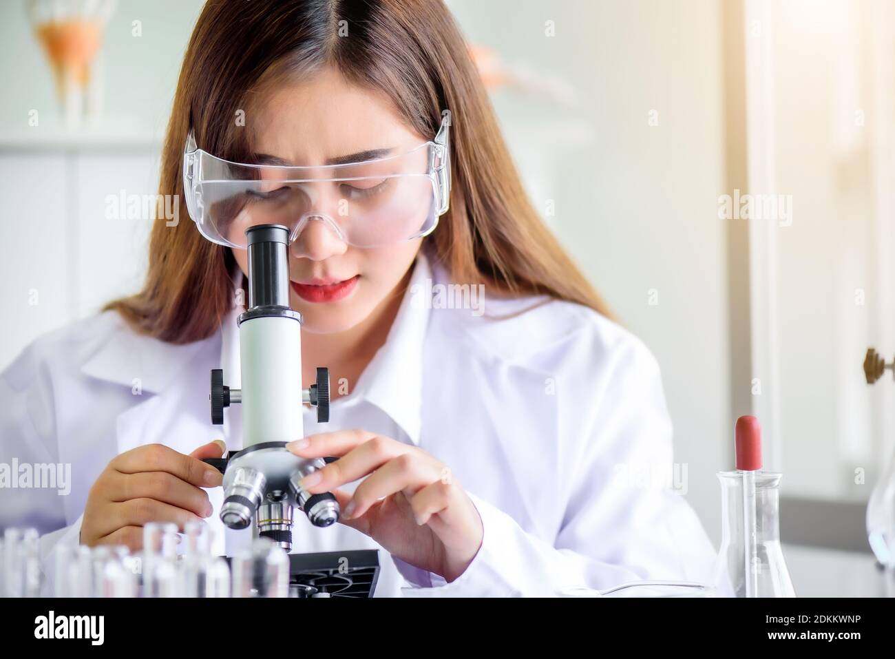 Female Scientist Looking Through Microscope Stock Photo - Alamy
